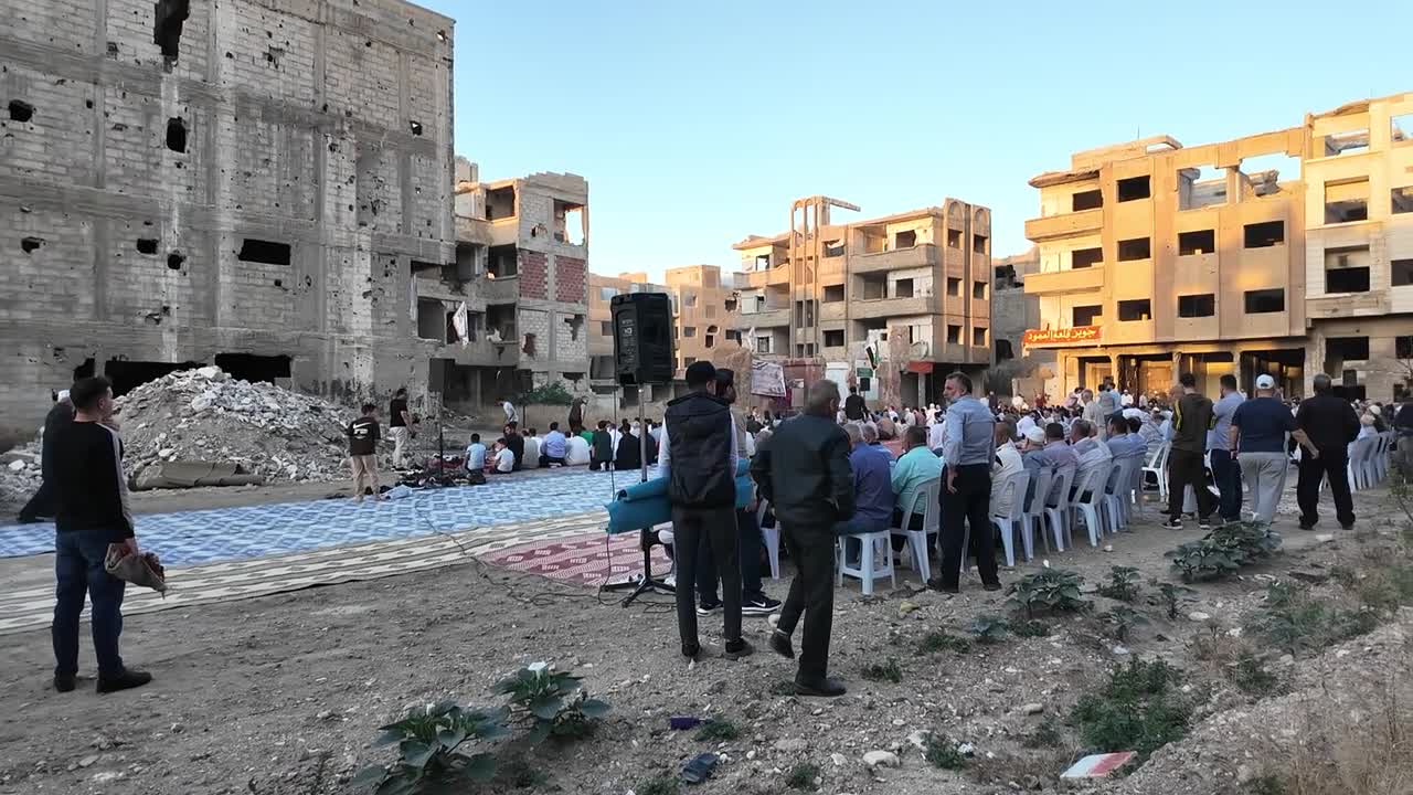 Muslims gather for Eid al-Adha prayers in damaged square in Syria