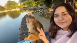 Woman poses with monkey