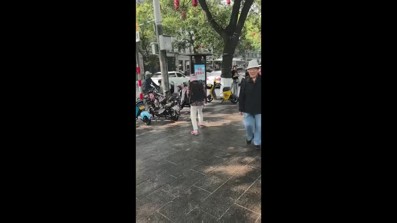 Person struggles to walk as shoes stick to pavement in Beijing, China