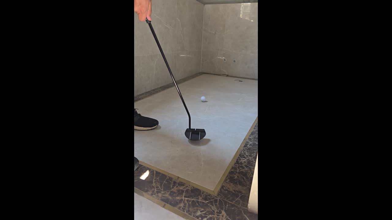Golfer practices putting on bathroom's marble floors
