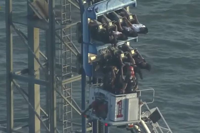 Riders left dangling mid-air after rollercoaster breaks down during 90 ...