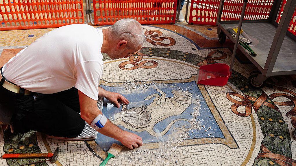 Italy gives bull mosaic testicles worn down by spinning tourists some TLC