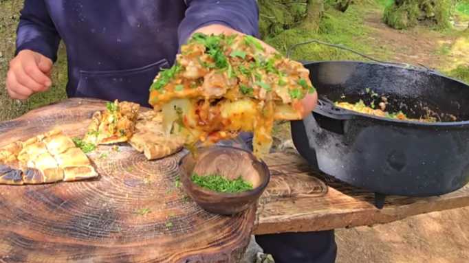Watch how chicken stew and stone baked bread come together in the forest