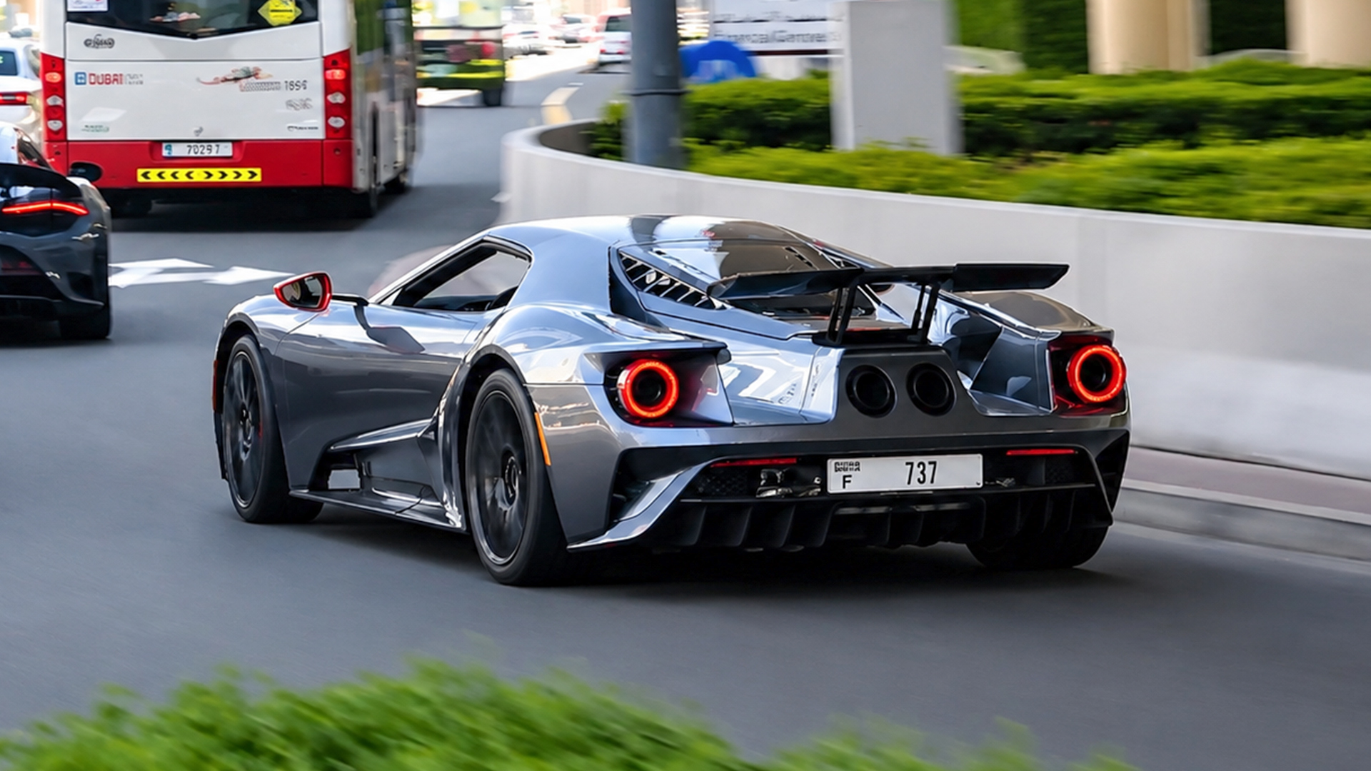 Silver Ford GT of Dubai millionaire rolling past urban roads