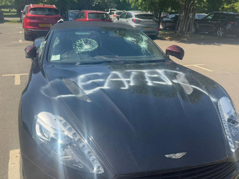 Mystery man smashes up £200,000 Aston Martin and sprays 'cheater' over it