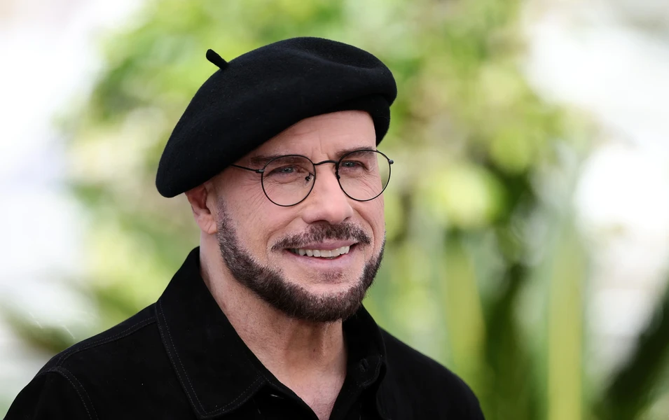 John Travolta’s Cannes beret look doubles as directorial debut statement