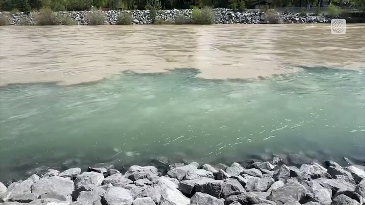 Murky spring melt visible in the Bow River in Canmore, AB