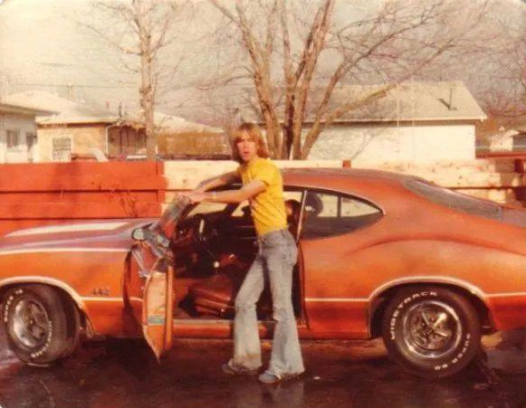 20 proud retro muscle car owners posing with their 1970s rides