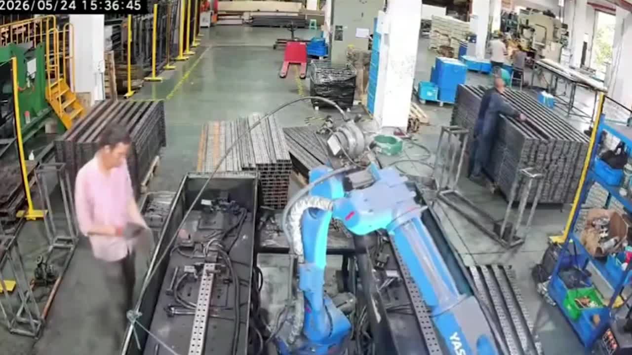 Industrial robot accidentally hits worker in manufacturing plant