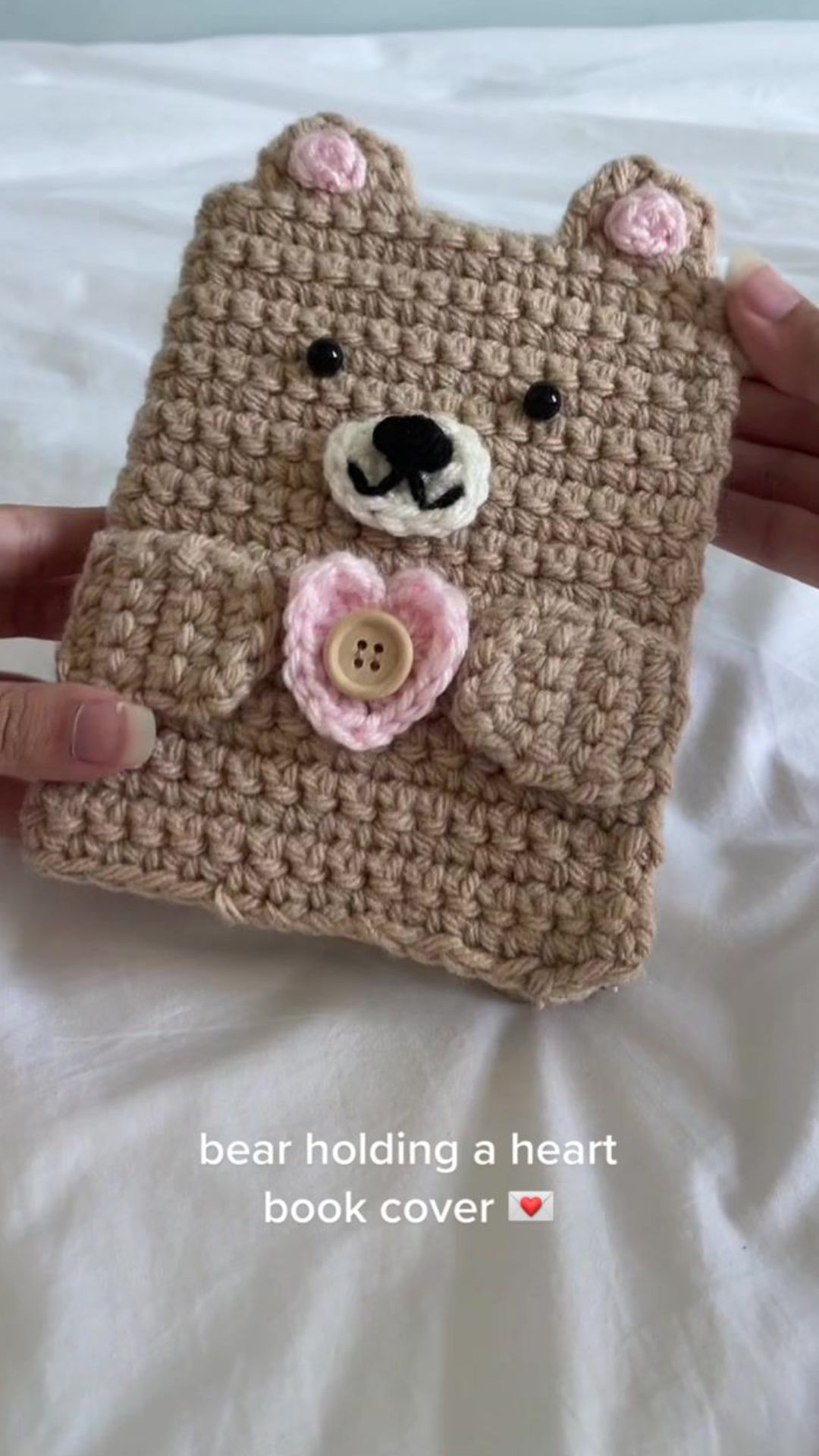 DIY crochet book cover featuring a bear holding a heart