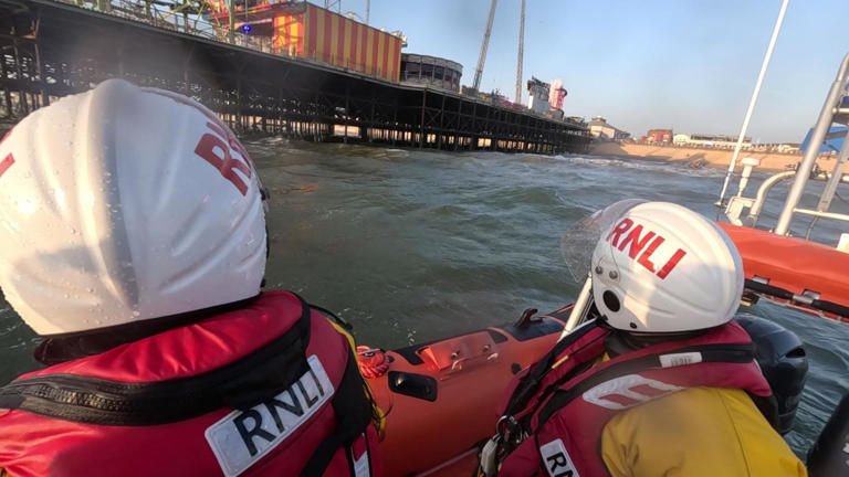 Two children and adult clinging to pier saved by RNLI