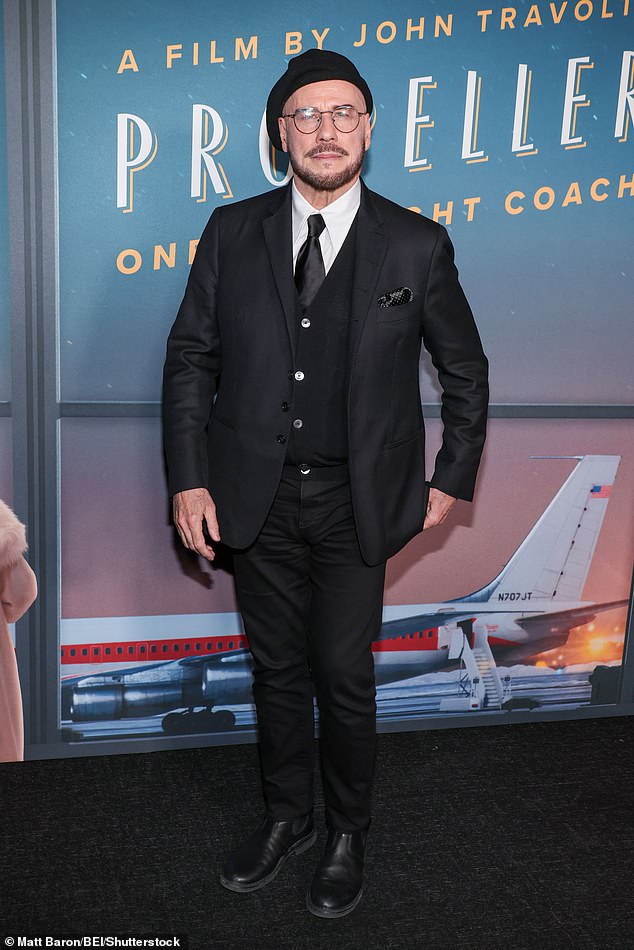 John Travolta continues to sport his kooky new look with another beret