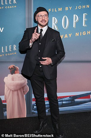 John Travolta continues to sport his kooky new look with another beret