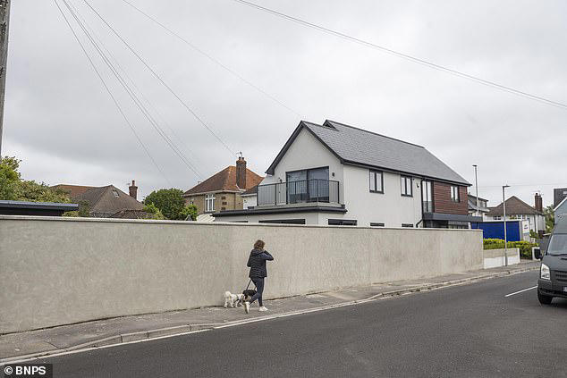 Homeowner wins planning fight with angry neighbours over 7ft concrete ...