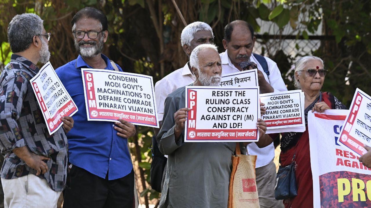 IN PHOTOS CPM activists stage protest at Azad Maidan over raid at ...