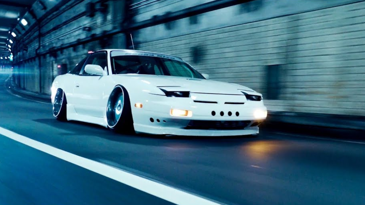 Tatsumi PA night scene featuring iconic JDM cars
