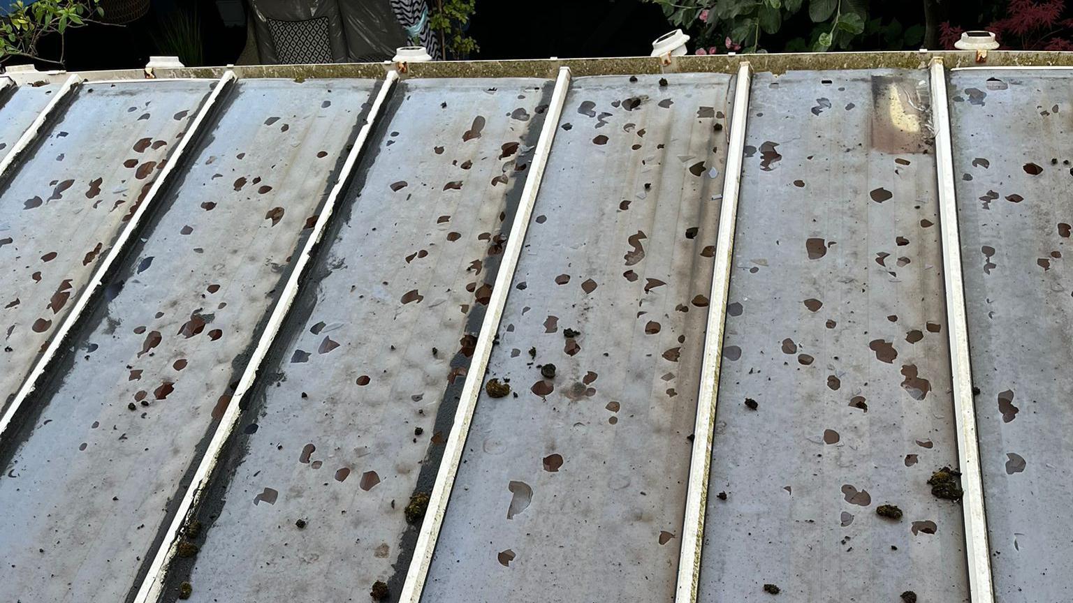 Golf ball-sized hailstones damage roofs and cars