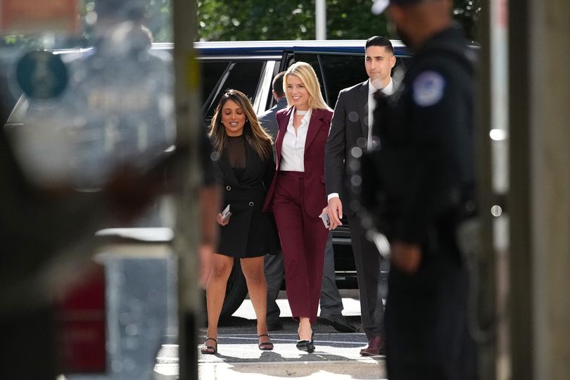 Pam Bondi displays cancer bandage in open shirt as she arrives to face ...