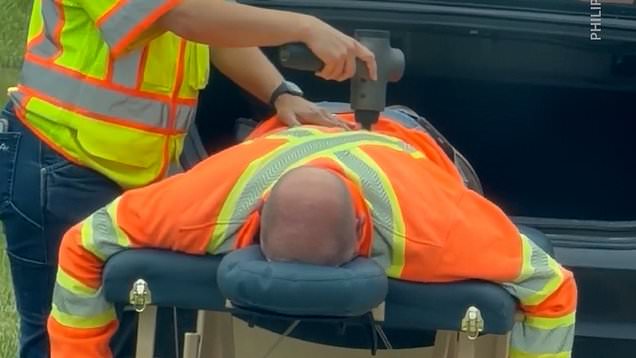 Construction worker gets roadside massage
