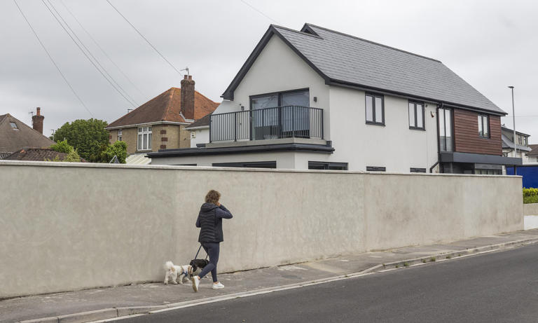 Homeowner wins planning fight with angry neighbours over 7ft concrete ...