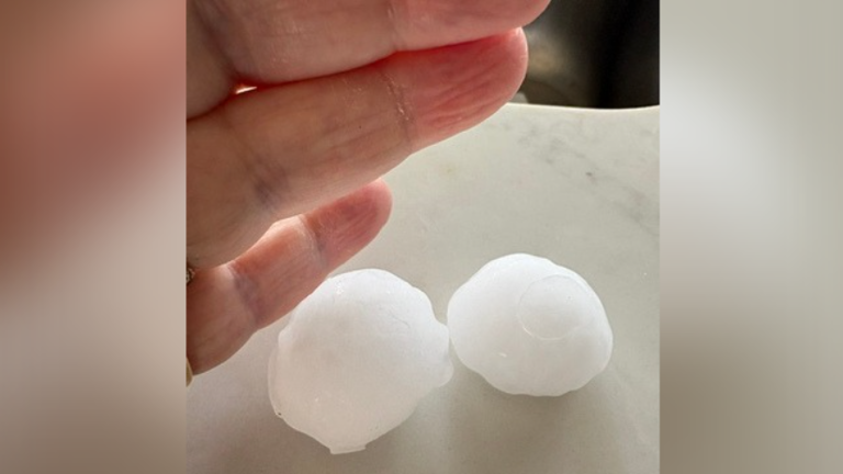 Golf ball-sized hailstones damage roofs and cars