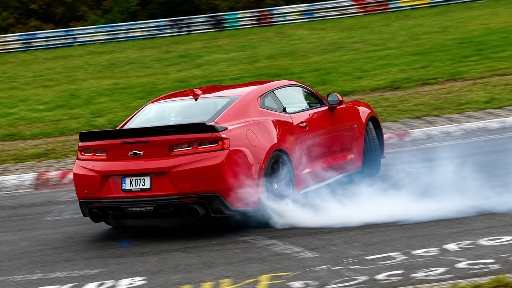 Chevy Camaro loses grip and spins out mid-corner, creating a close call