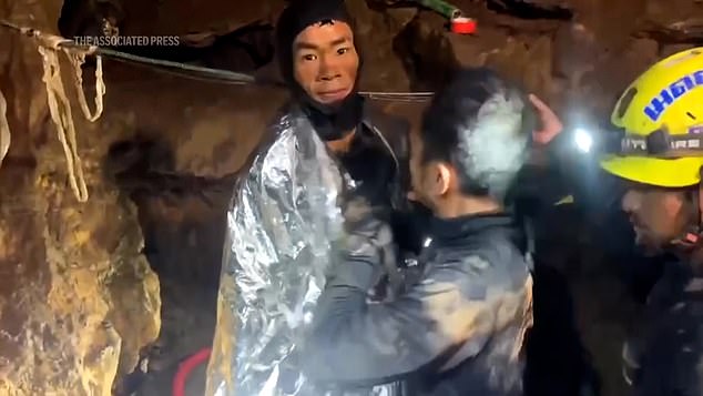Astonishing moment specialist divers rescue first of seven men trapped ...