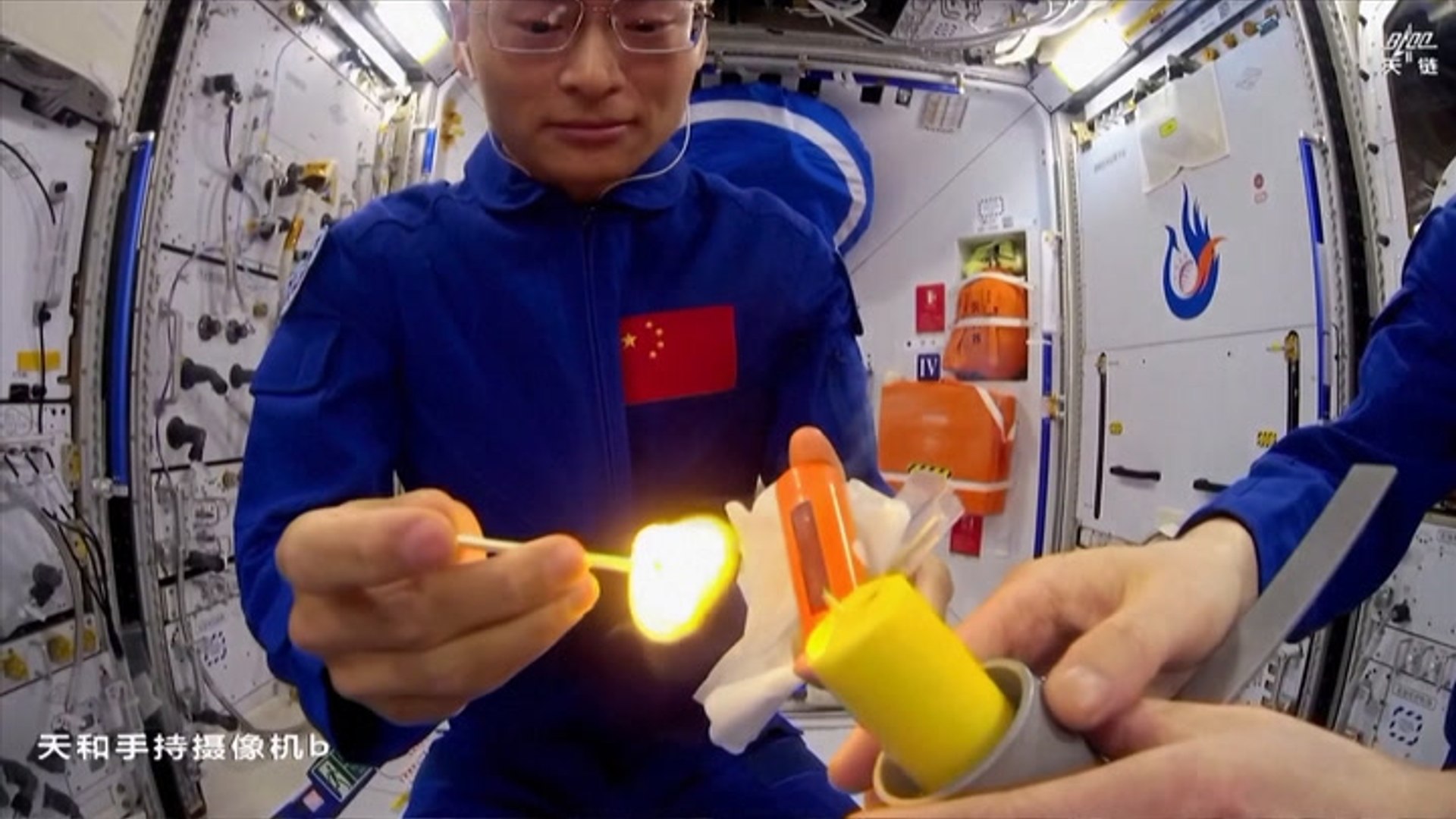 Chinese astronaut lights a candle with match on Tiangong space station ...