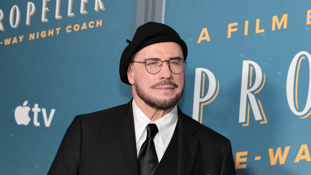 Travolta defends beret look amid film debut buzz