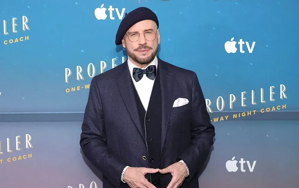Travolta defends beret look amid film debut buzz