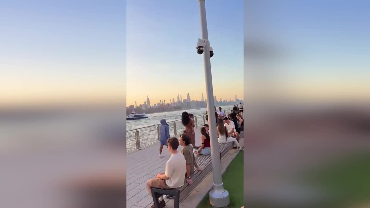 Stunning sunset views over Manhattan from a busy Brooklyn waterfront park