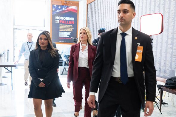 Bandaged Pam Bondi spotted making preening gesture before tense Epstein ...