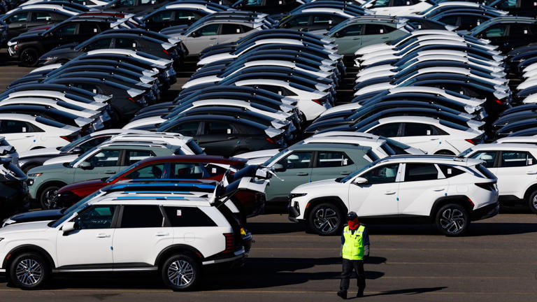 Automakers stockpile vehicles amid war-shaken supply chains