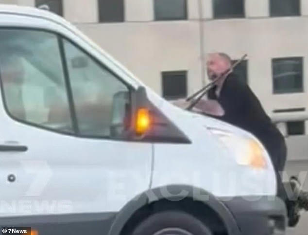 Dramatic moment angry driver jumps on the bonnet of a moving van ...