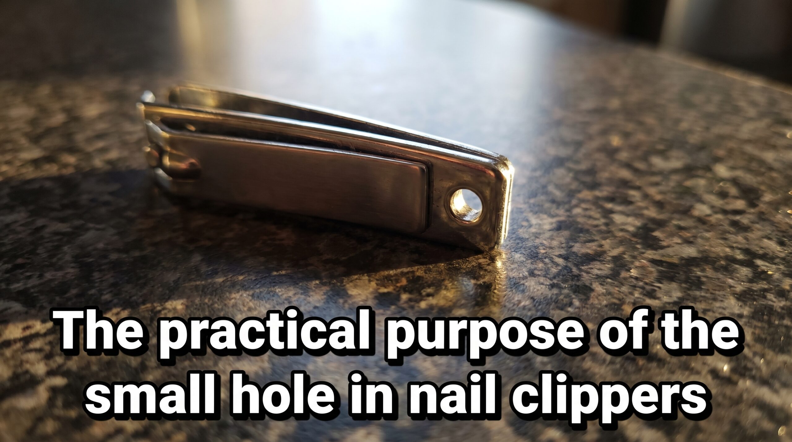 The practical purpose of the small hole in nail clippers