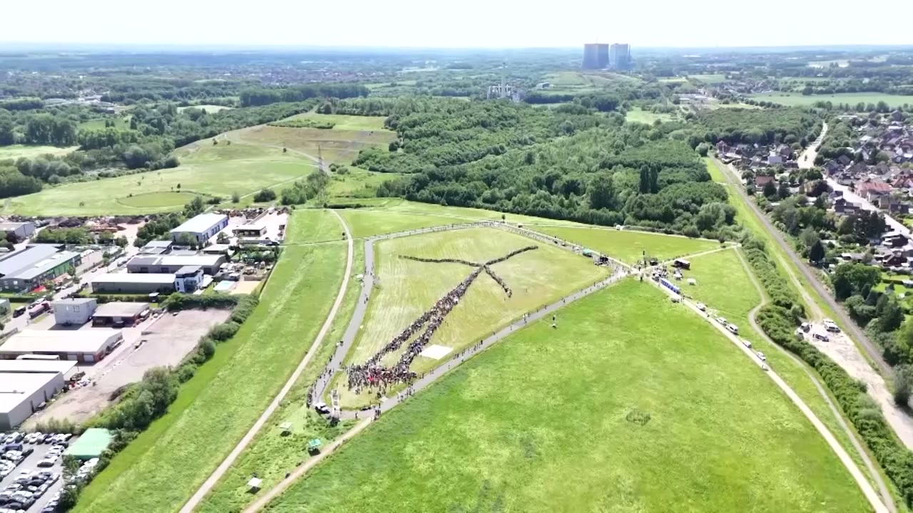 German protestors form windmill to oppose natural gas production