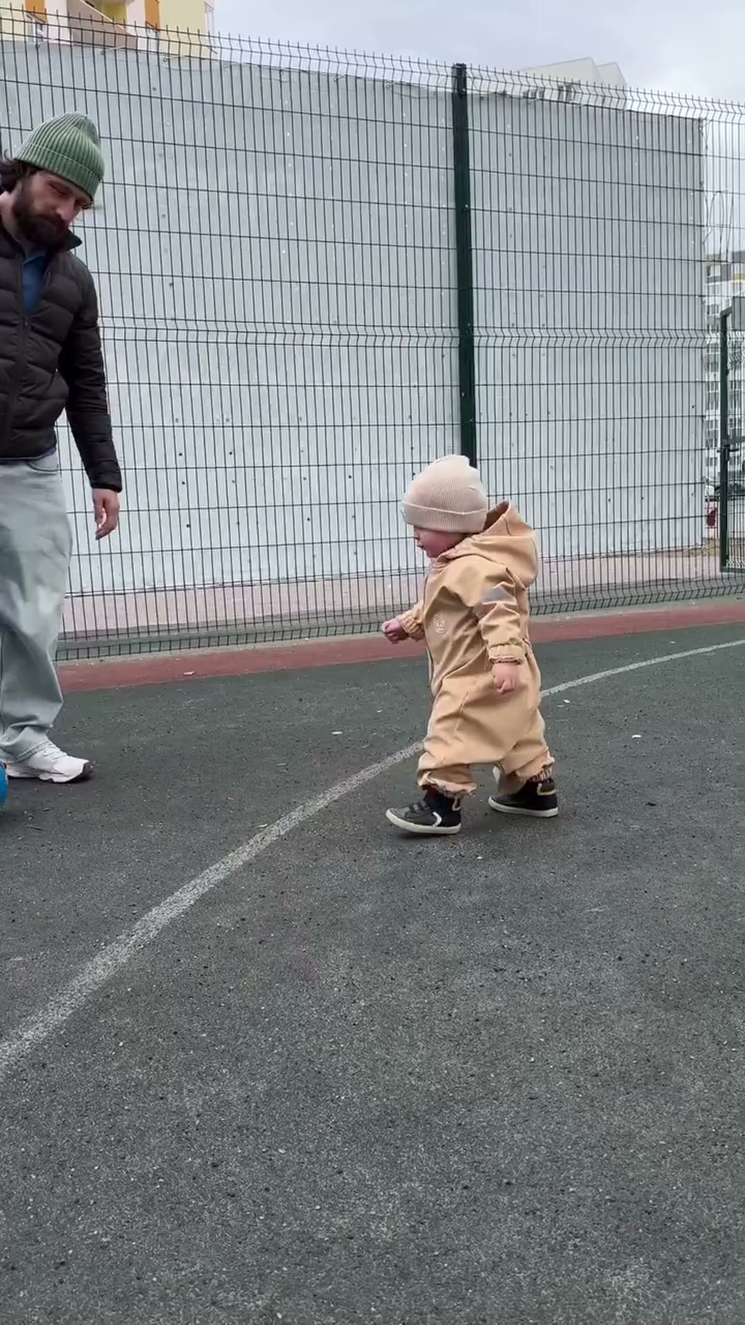 Tiny soccer star taking first kicks with dad