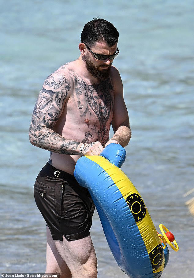 Megan McKenn shows off her figure as she hits the beach amid family ...
