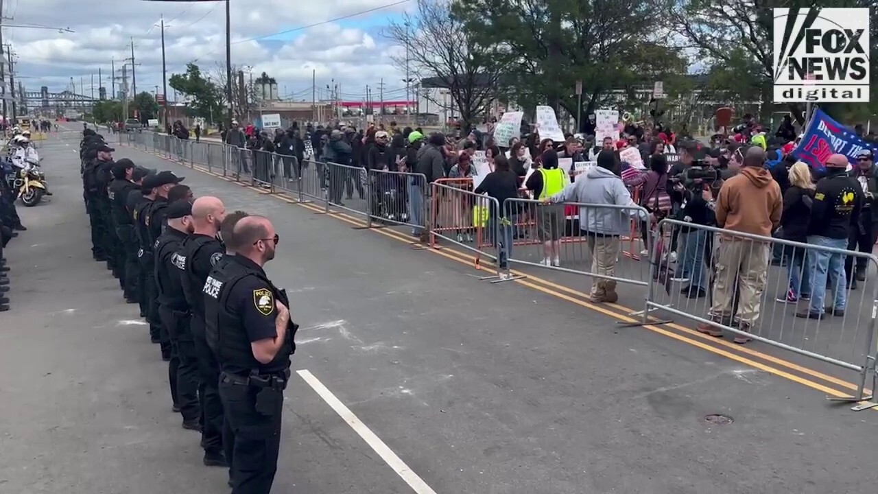 New Jersey authorities stand across from protesters outside Delaney ...