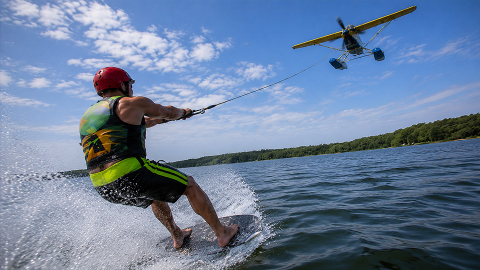 Barefoot skier gets pulled behind airplane at speed