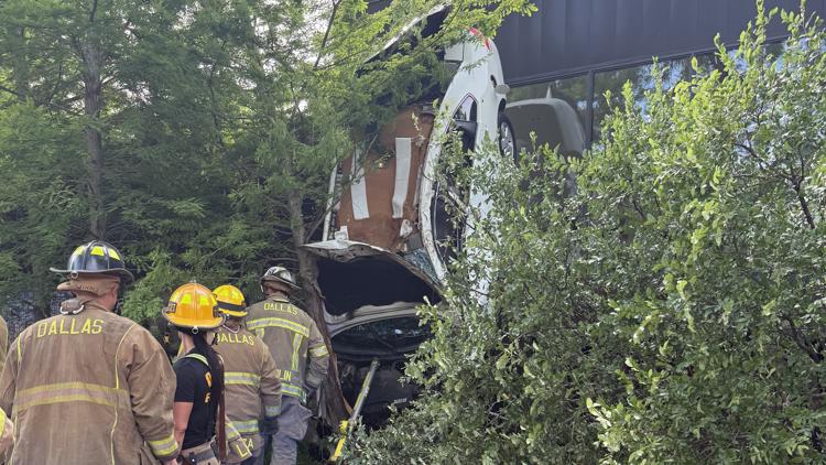 Dallas firefighters rescue driver after car crashes vertically between ...