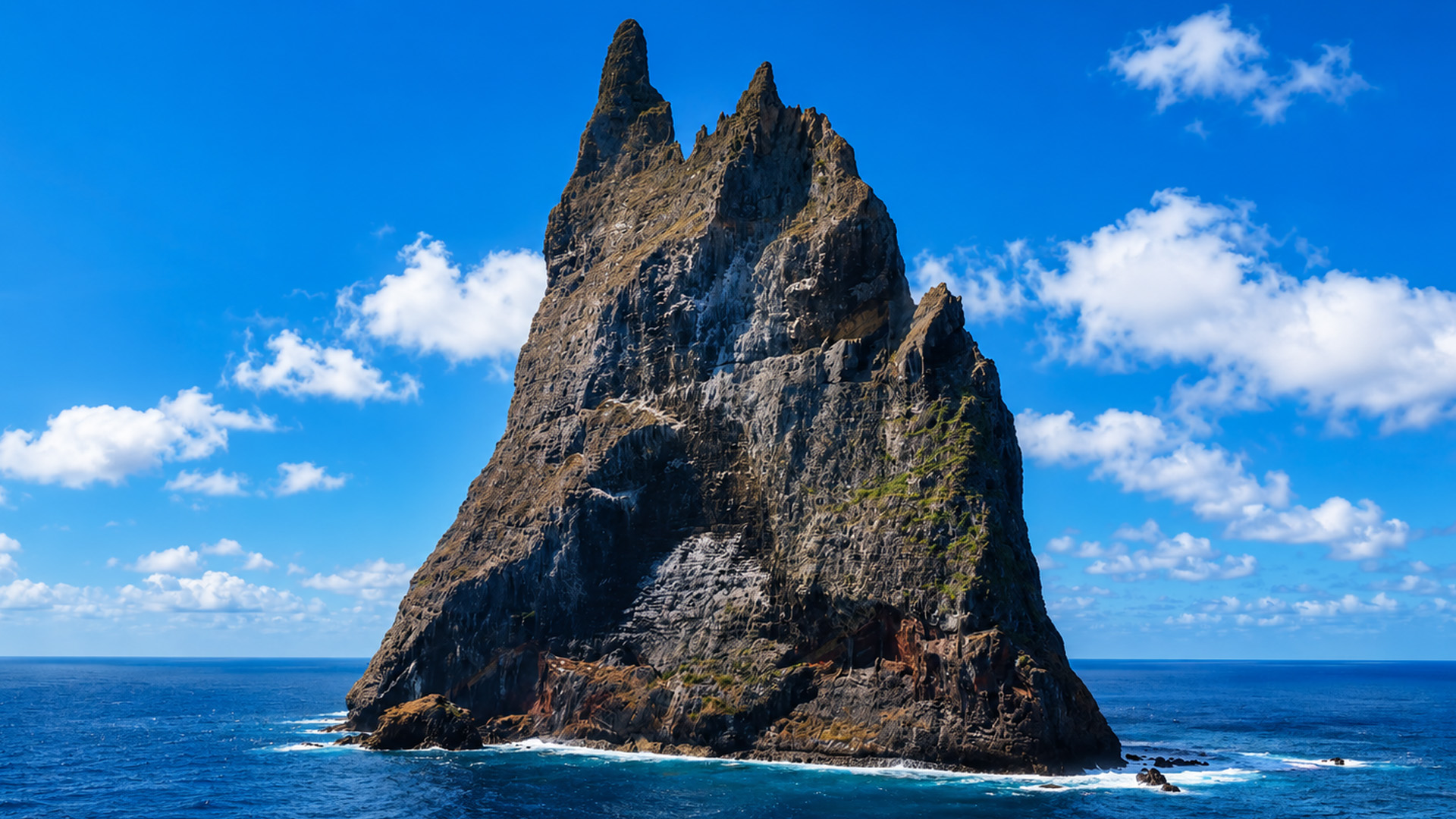 A volcanic tower rising from the ocean