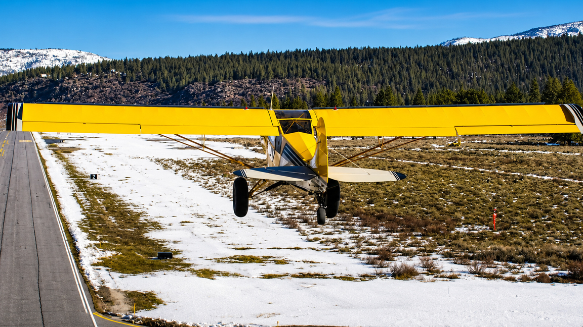 The tiny plane taking off into a frozen wilderness