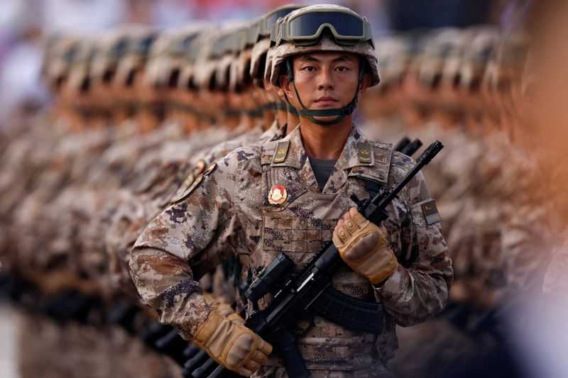 Japan rejects 'new militarism', accuses China of rapidly arming