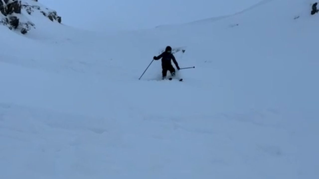 Skier loses an edge and slides out on the slope