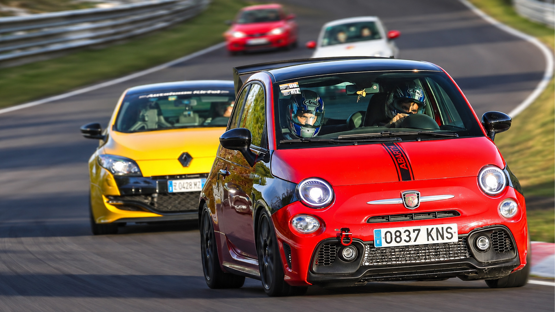 Small Abarth takes on a packed race track