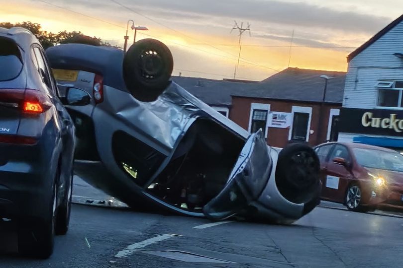 Emergency services descend on busy Rochdale junction as car lands on ...