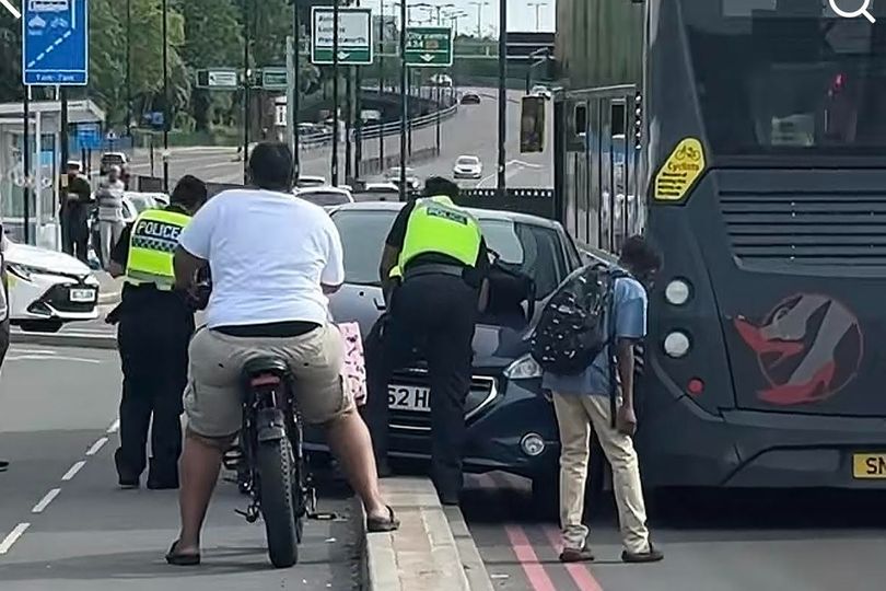 Car facing wrong way trapped beside bus on busy Birmingham route as ...