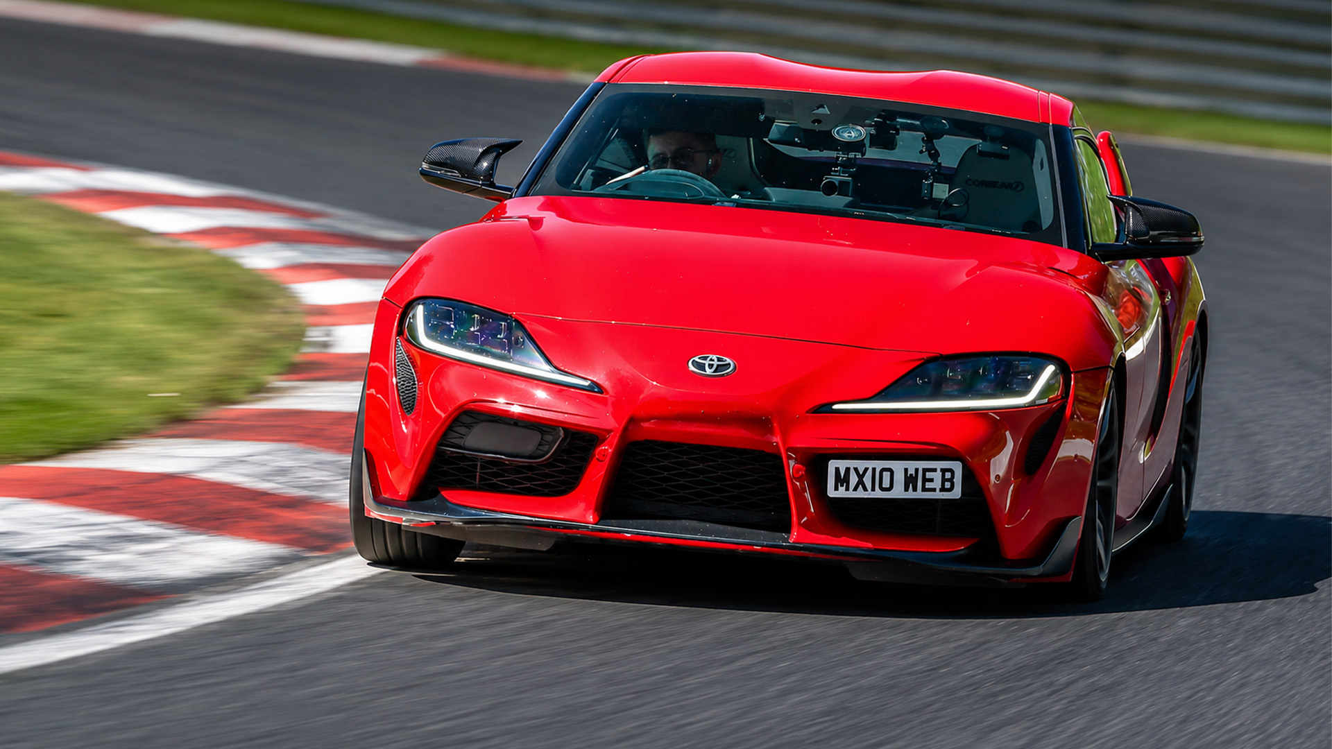 Red Toyota Supra chases speed through corners
