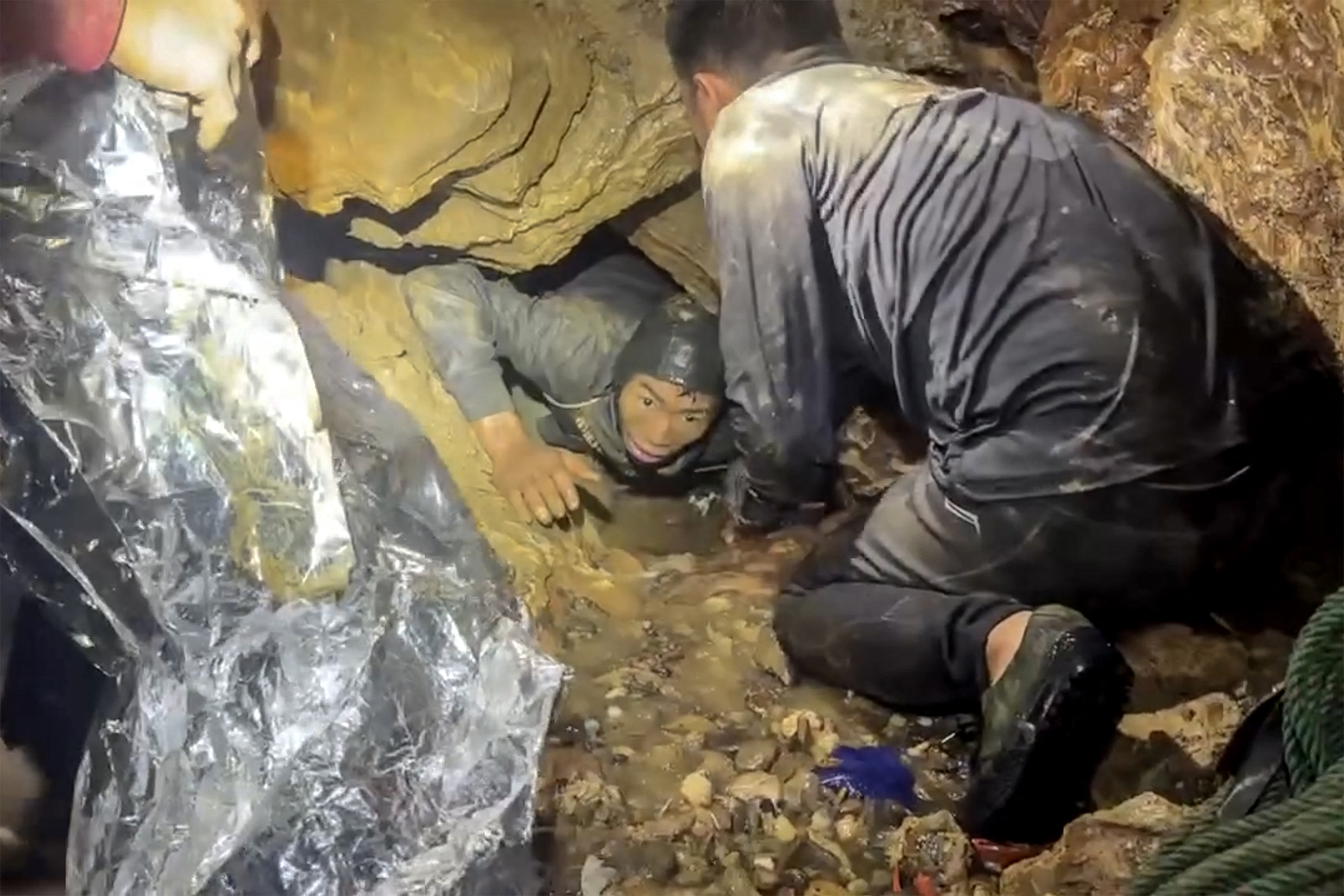 Rescuers race to save two people still trapped in cave in Laos